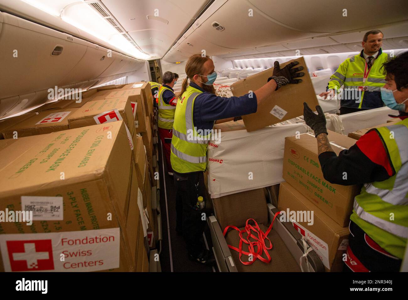 Workers unload boxes containing Personal Protection Equipment (PPE ...