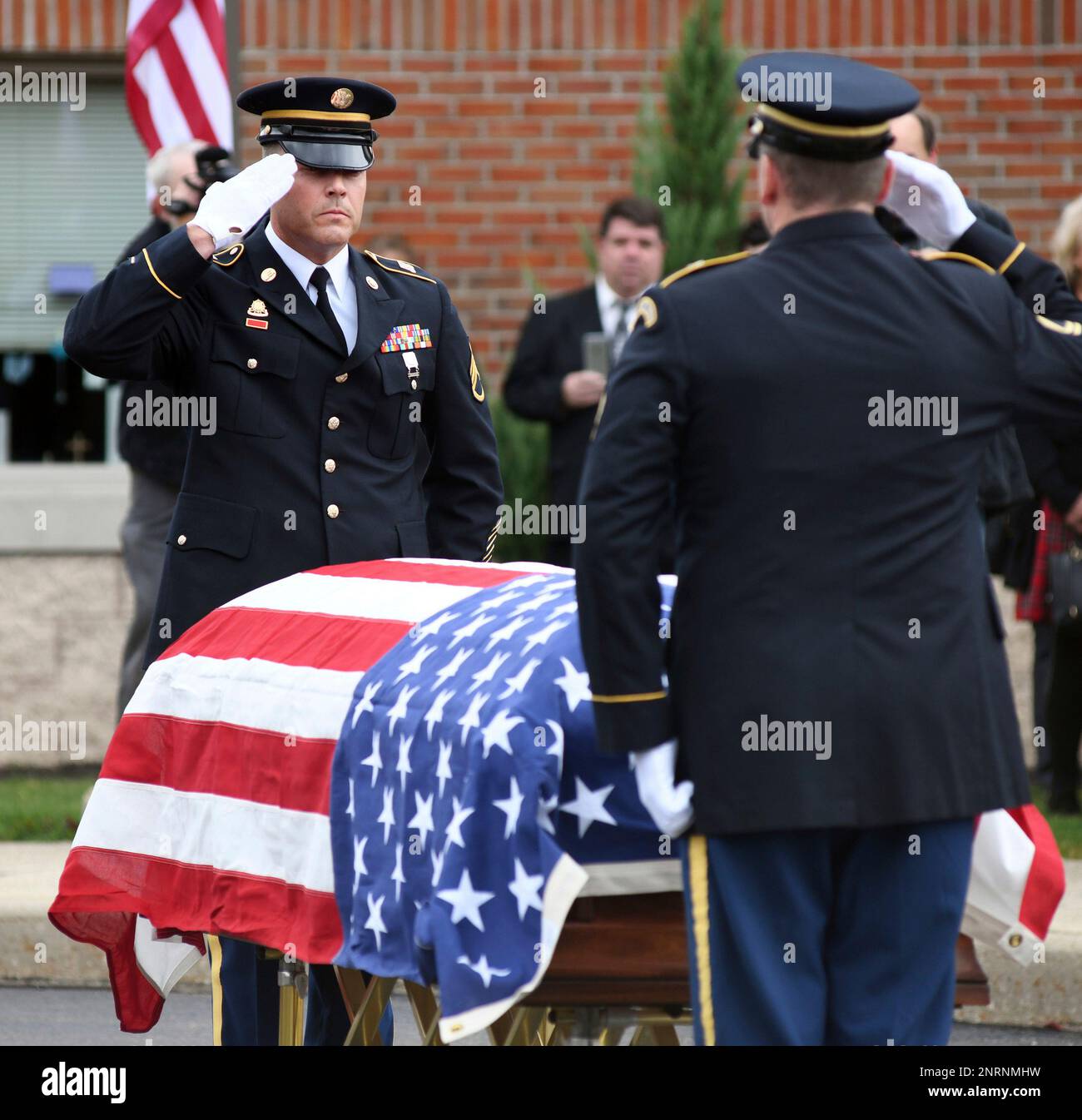 A U.S. Army active duty honor guard prepares to present the family of ...