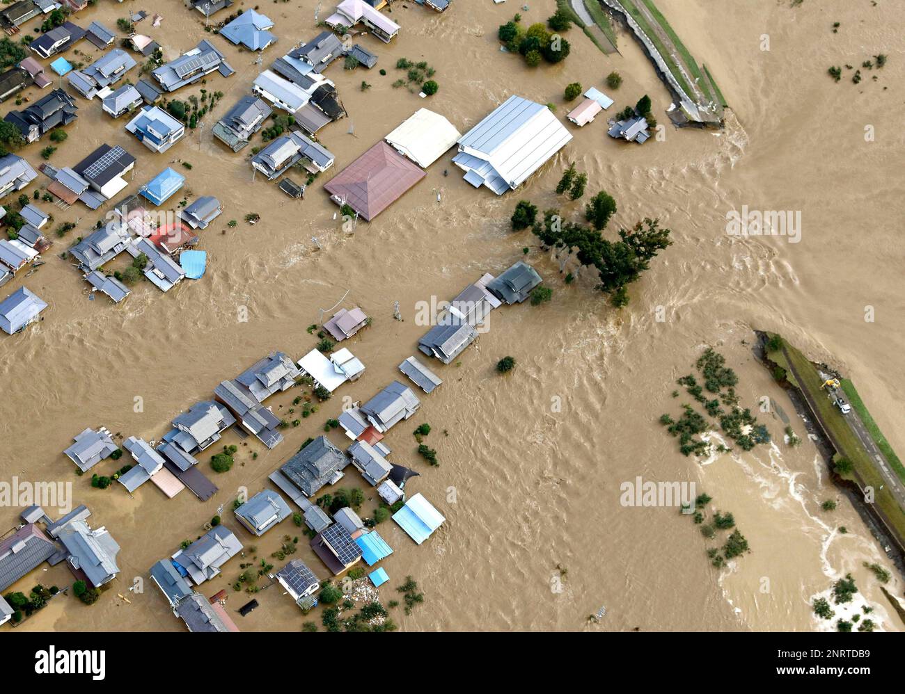 Residential area is seen in muddy waters after an embankment of the ...