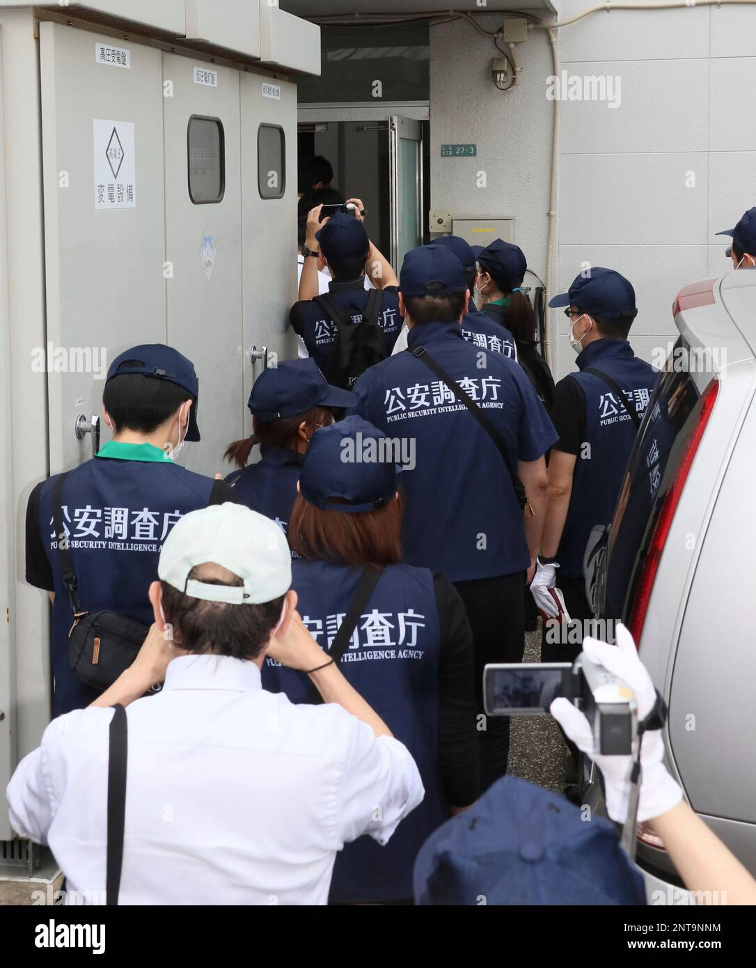 Police officers enter Aleph, the group whose name was changed from Aum ...