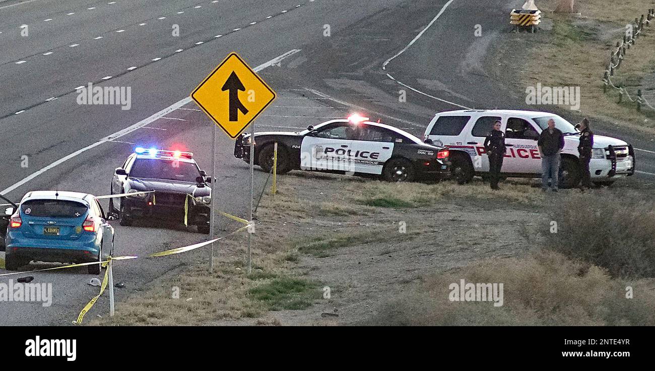 In this March 17 2019 photo, Albuquerque Police officers investigate a ...
