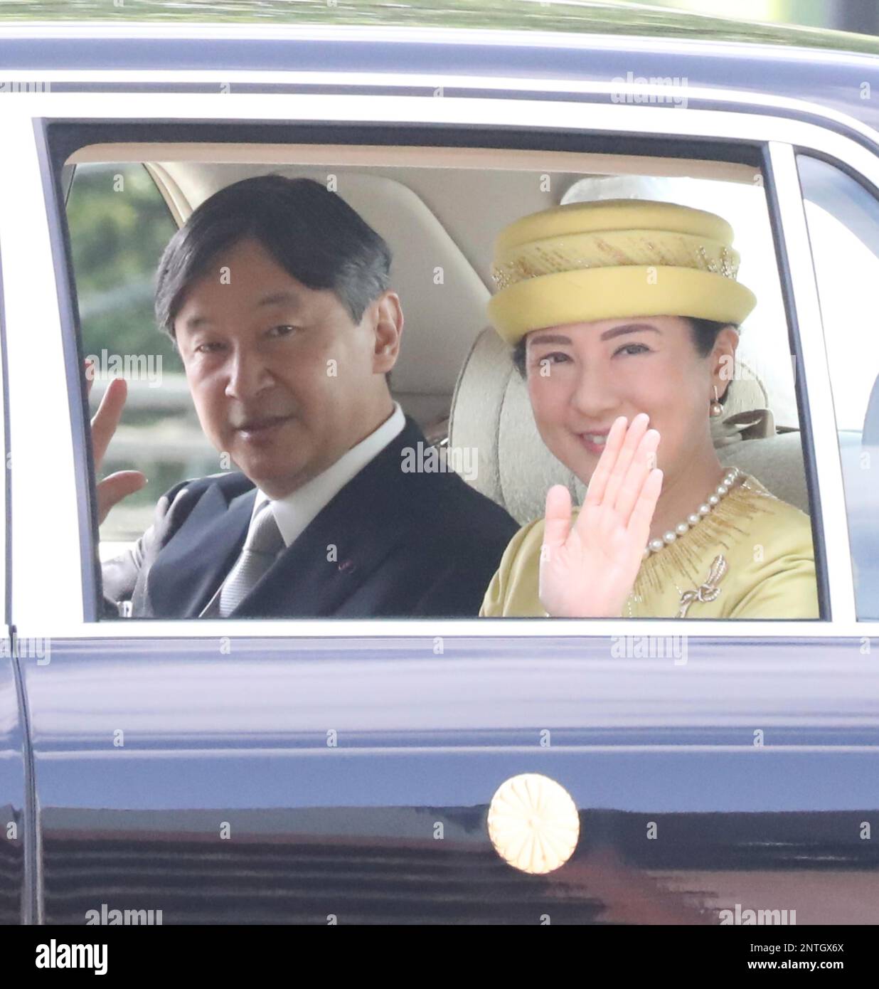 Japan's new Emperor Naruhito and Empress Michiko enter the Imperial Palace to attend their first ...