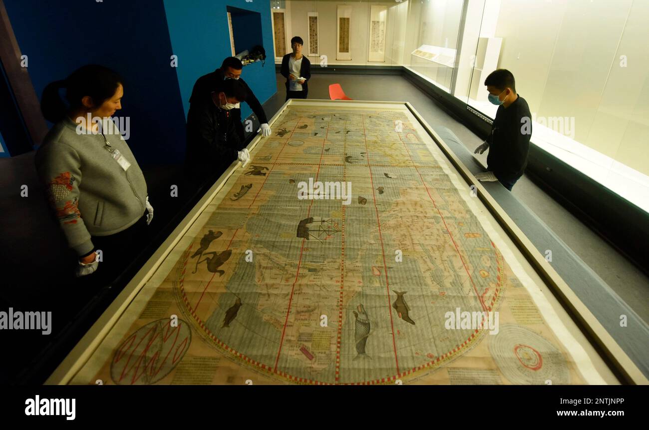 Workers prepare for the exhibition of the 1608 A.D. imperial copy of ...