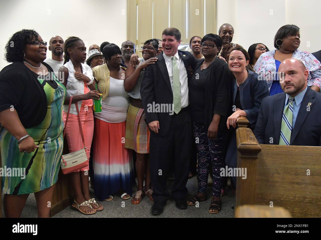 District Attorney Ben Coker, center left, and Assistant District ...