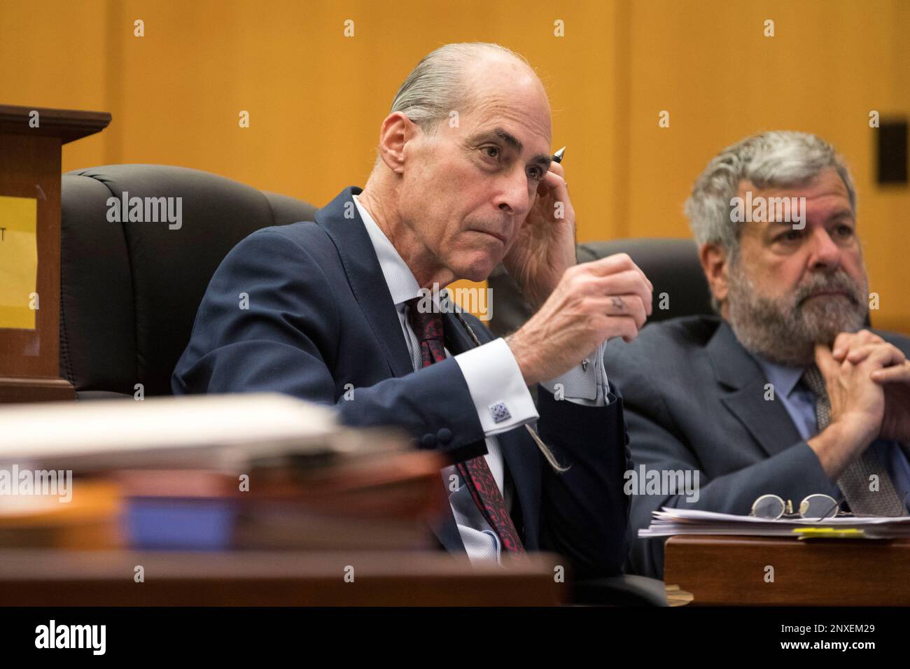 Defense attorney Bruce Harvey, left, looks toward a potential juror as ...
