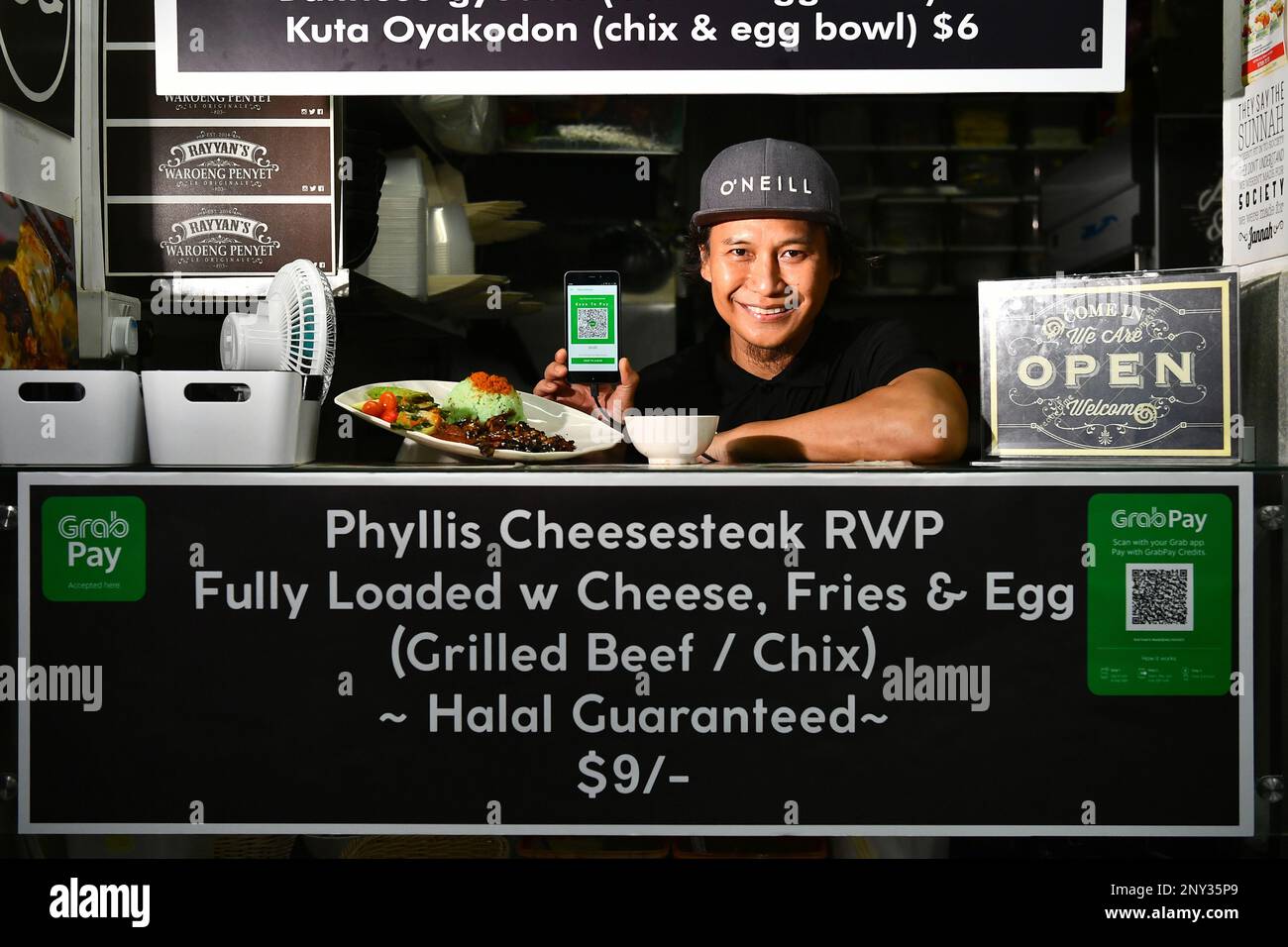 Mr Nornizam Bin Amin, 46, Owner of Rayyan's Waroeng Penyet, with the QR ...