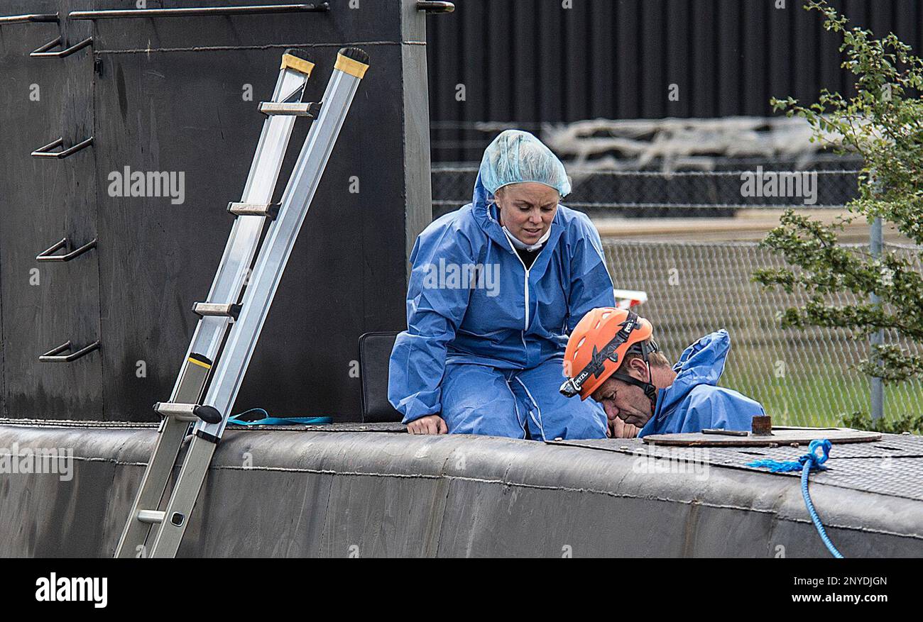 Police technicians board the amateur-built submarine UC3 Nautilus on a ...
