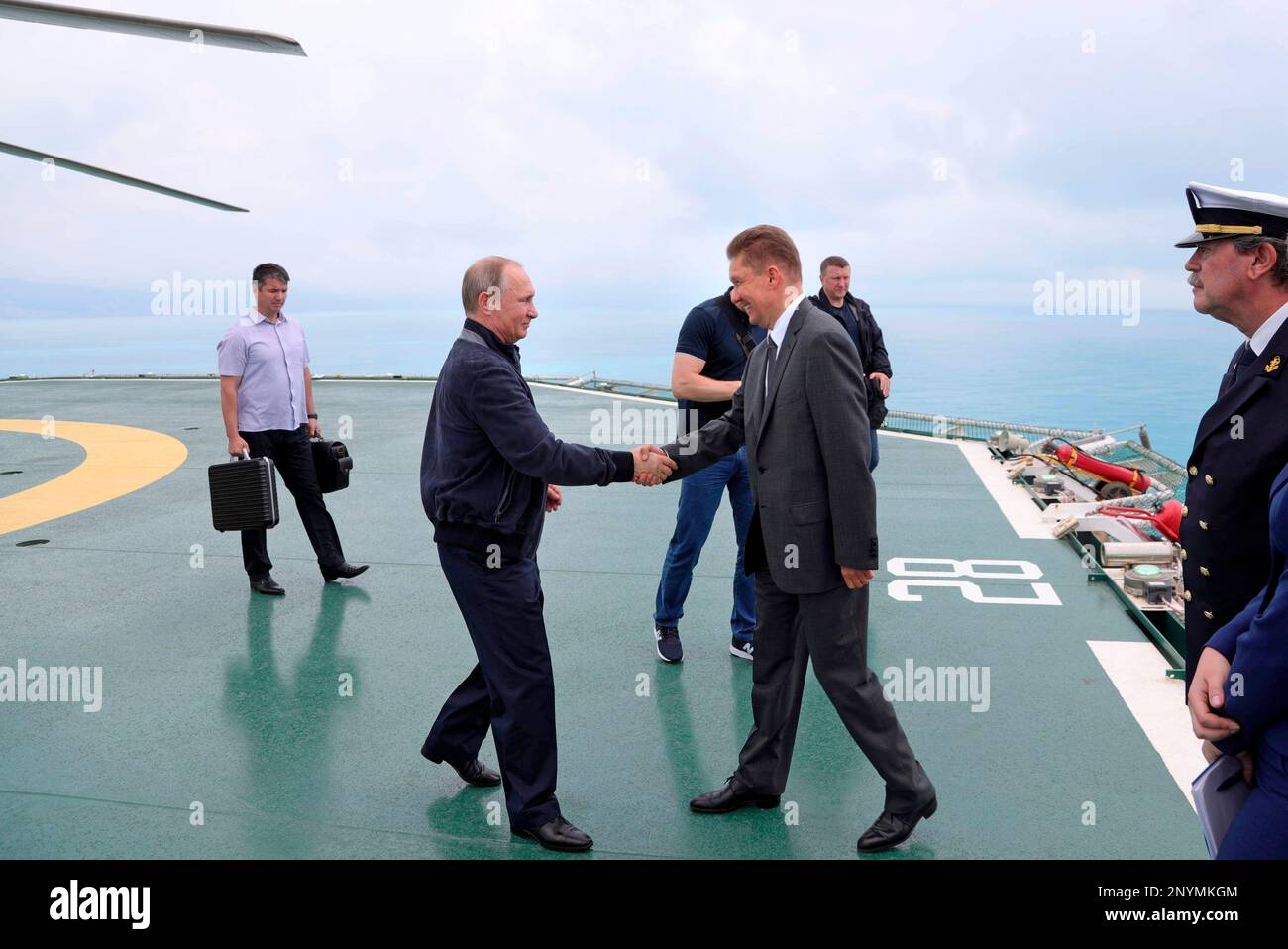 Russian President Vladimir Putin, left, shakes hands with Gazprom CEO ...