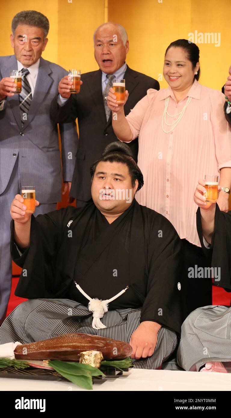 Sumo wrestler Takayasu (bottom ), poses with his parents father Eiji (C ...