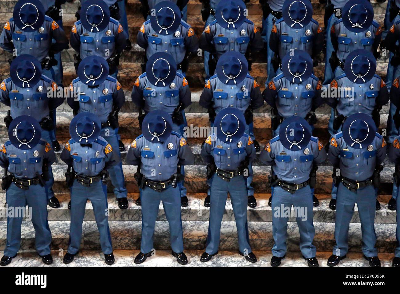 New Washington State Patrol troopers bow their heads during a prayer at ...