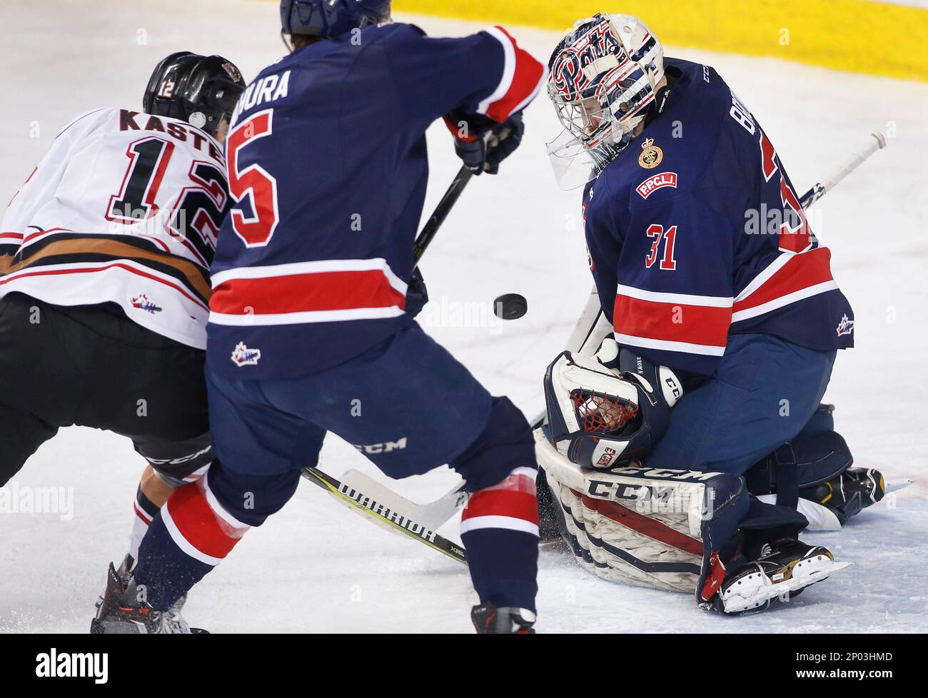 Regina Pats goalie Tyler Brown, right, makes a save against Calgary ...