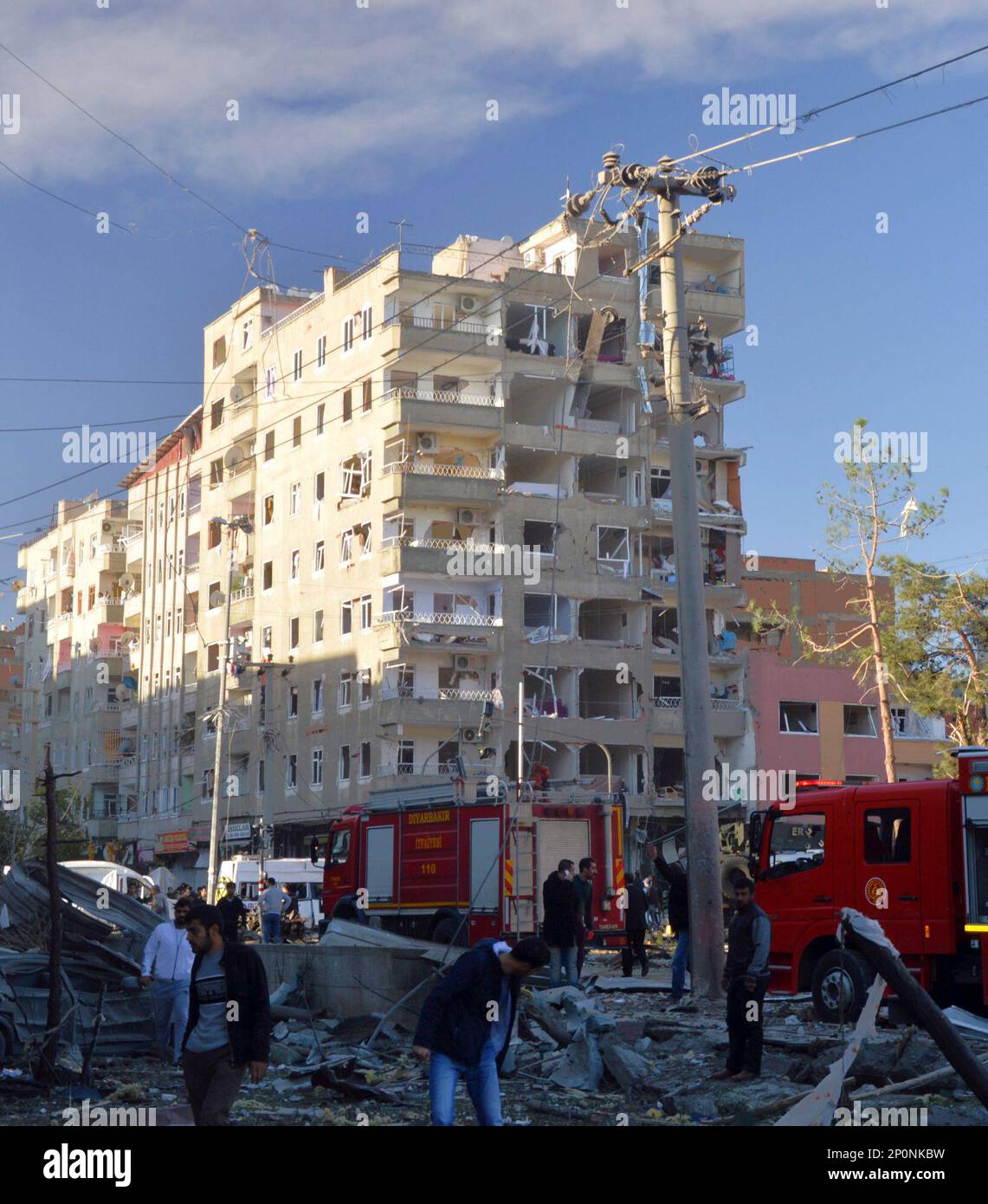 People watch the damage after an explosion in southeastern Turkish city ...
