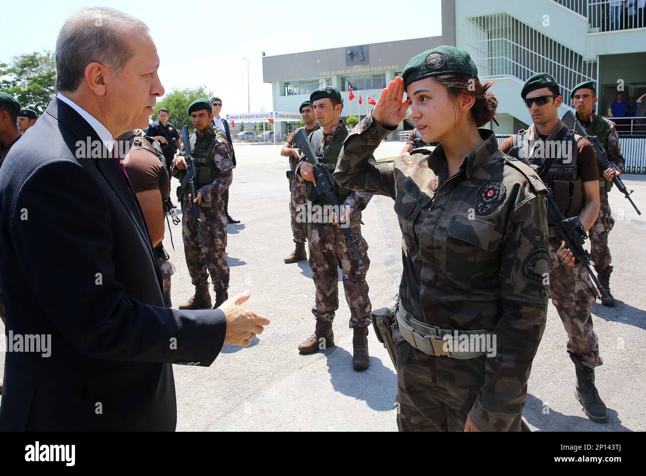 Turkey President Recep Tayyip Erdogan, left, greets a female member of ...