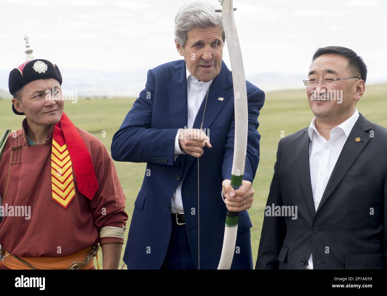 U.S. Secretary of State John Kerry, center, demonstrates his use of a ...