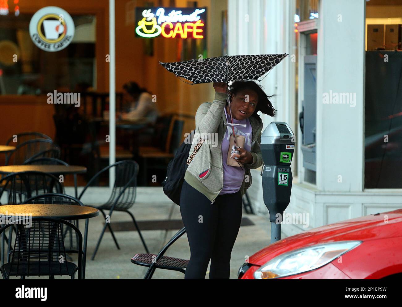 Nicole Brown of Hazelwood tries to save her umbrella that succumbed to ...