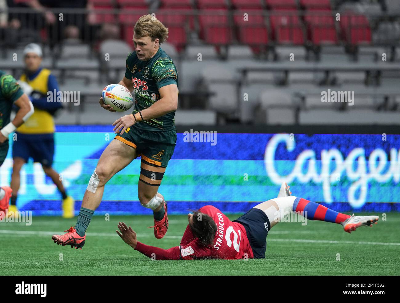 Australia's Darby Lancaster, left, runs for a try past Chile's Luca ...