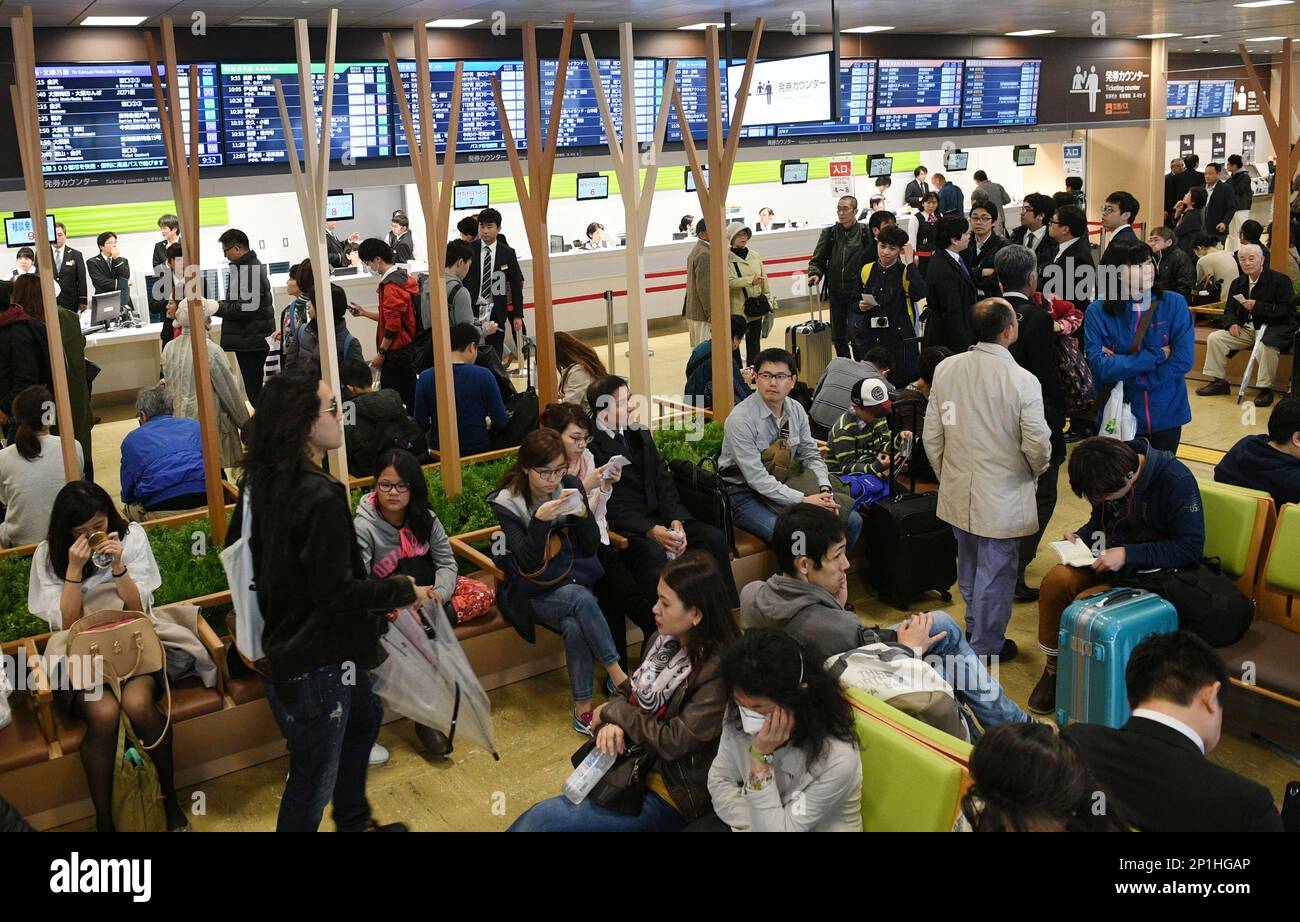 Passengers wait for a bus to leave at the Shinjuku Expressway Bus ...