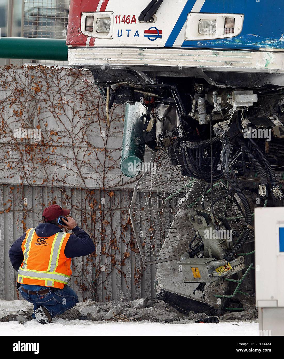 An investigator looks at a TRAX Green Line train after an accident ...