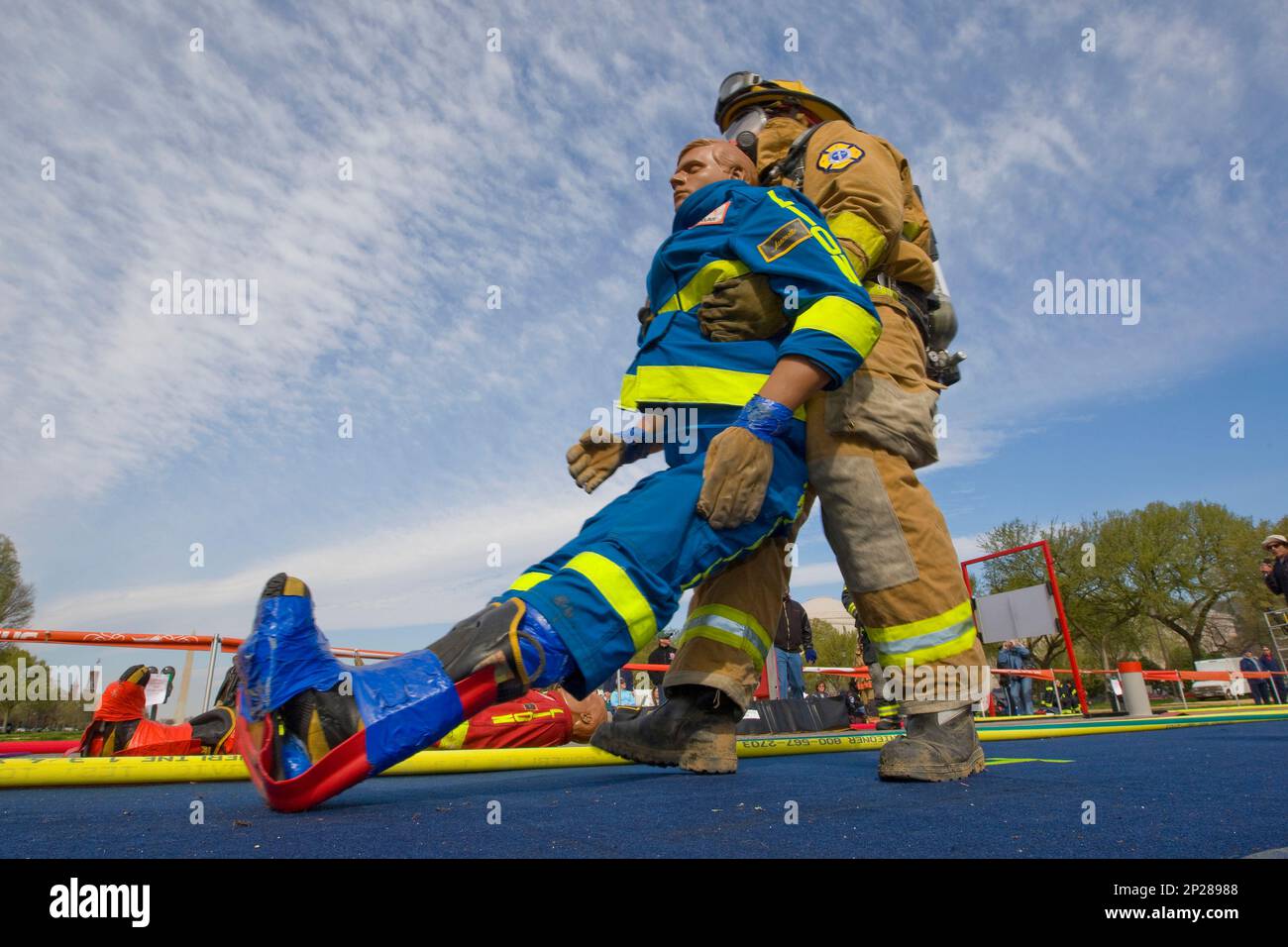 Here a firefighter picks up and drags "rescue Randy" during the ...