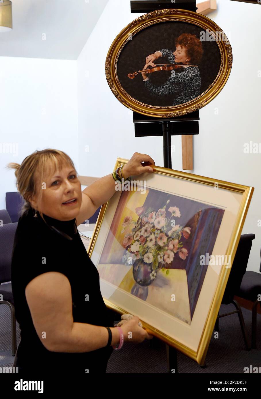 A painting of violin teacher Helen DePastel is put out on display in ...