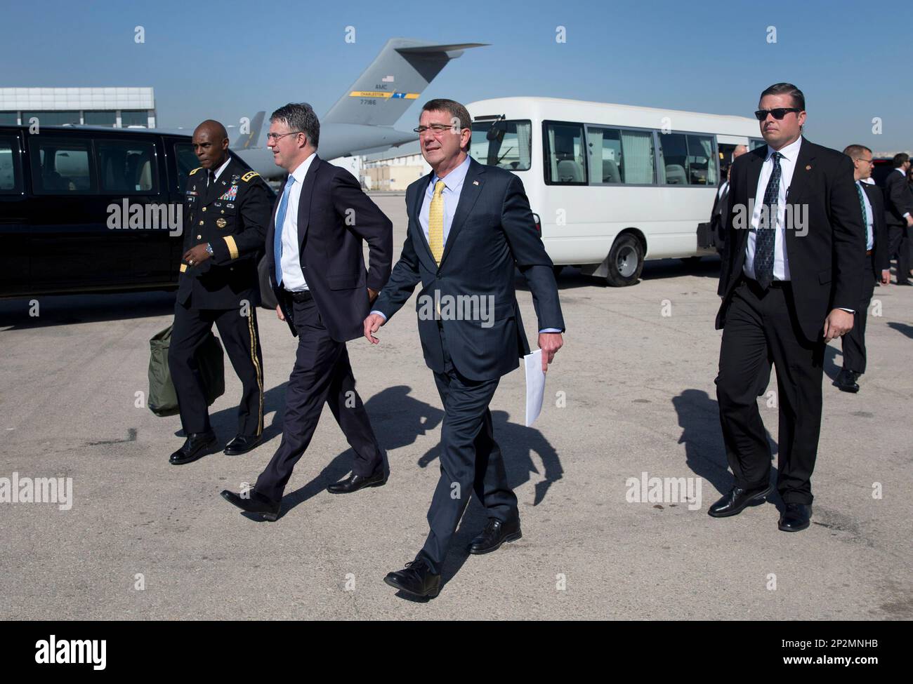 U.S. Defense Secretary Ash Carter walks along the tarmac with U.S. Army ...