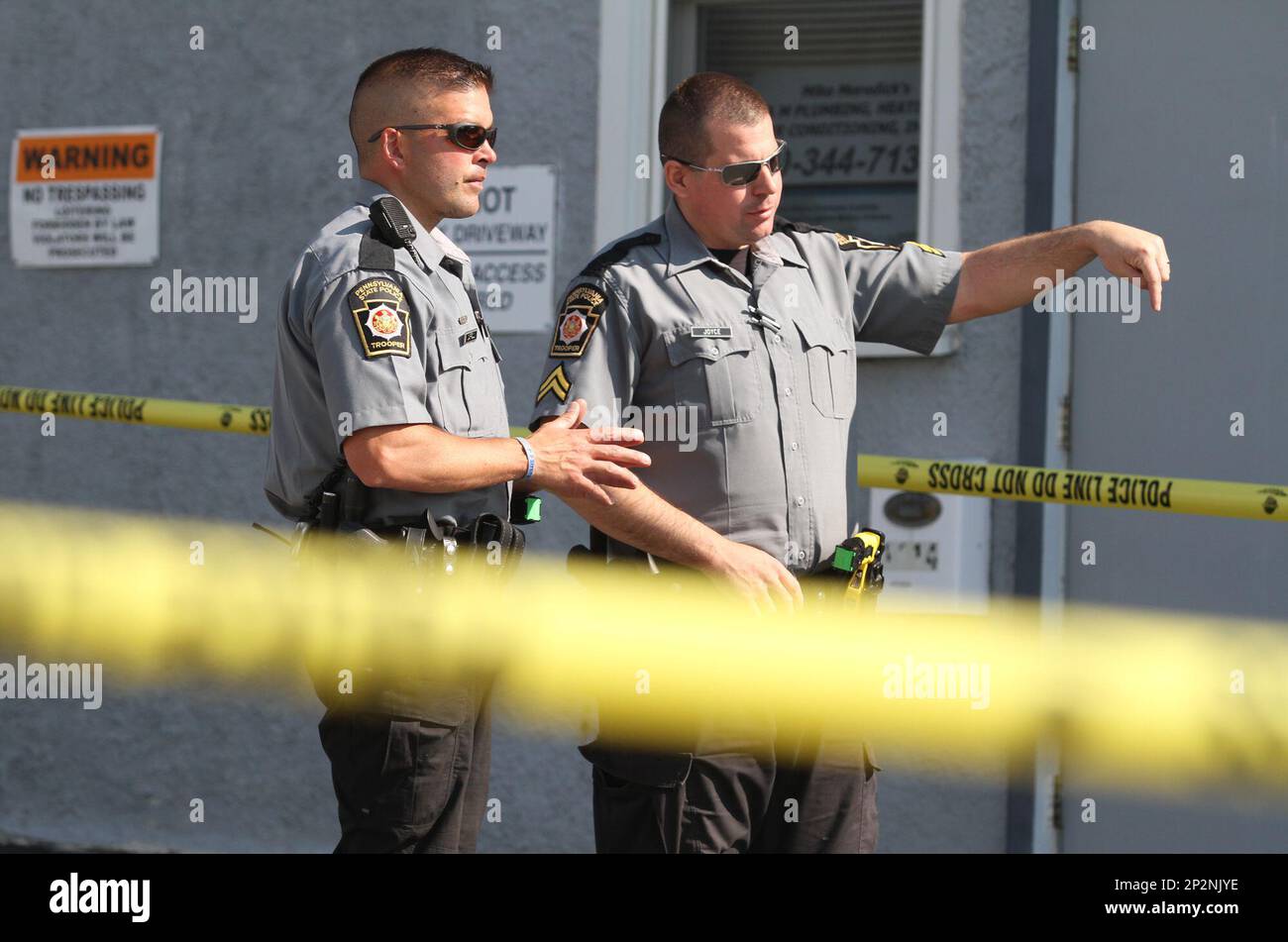 A Pennsylvania State Police Troopers investigate the scene where Scranton police officer John ...