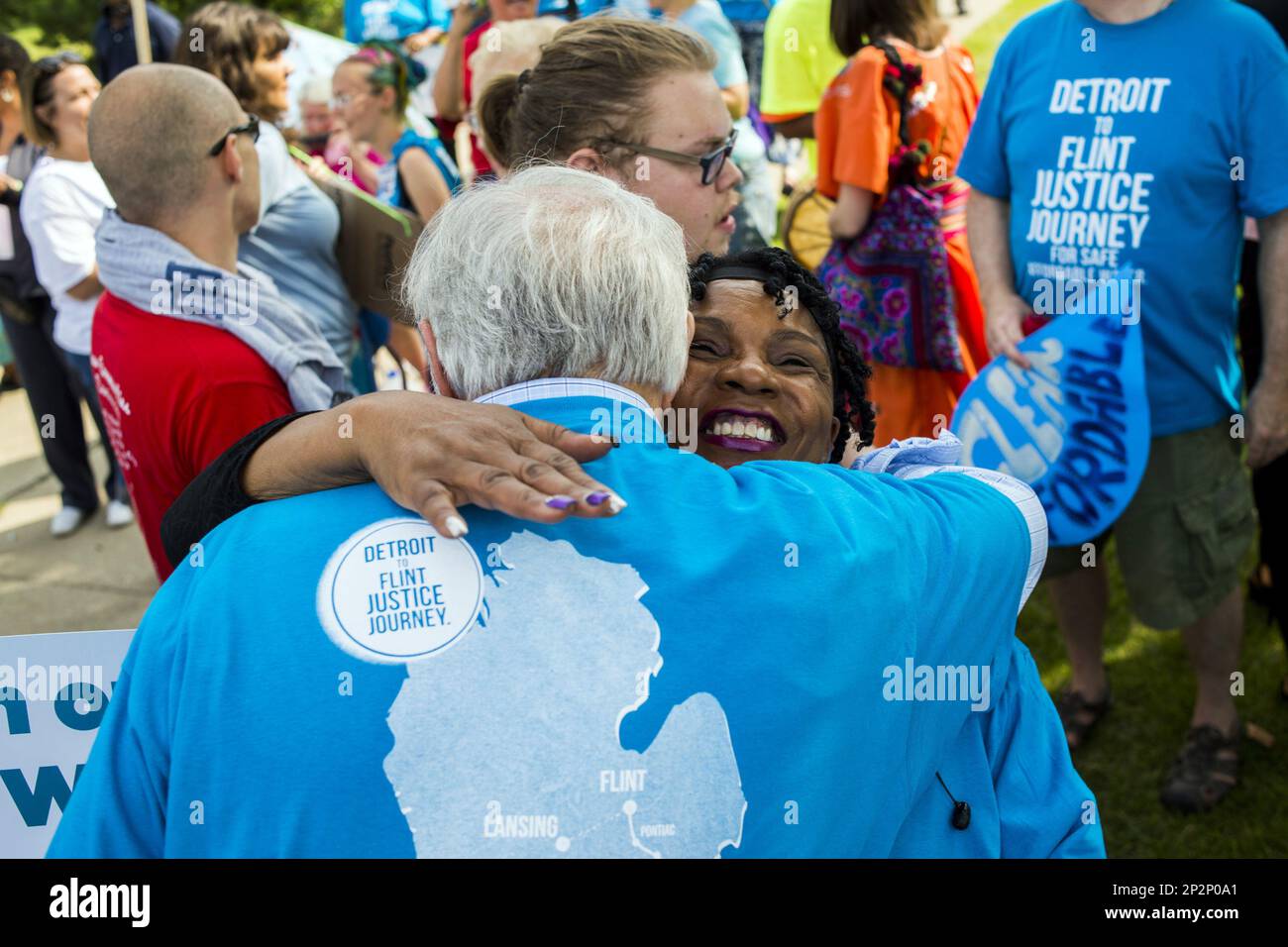Romulus resident Virginia Willams hugs Rev. Edwin Rowe of United ...