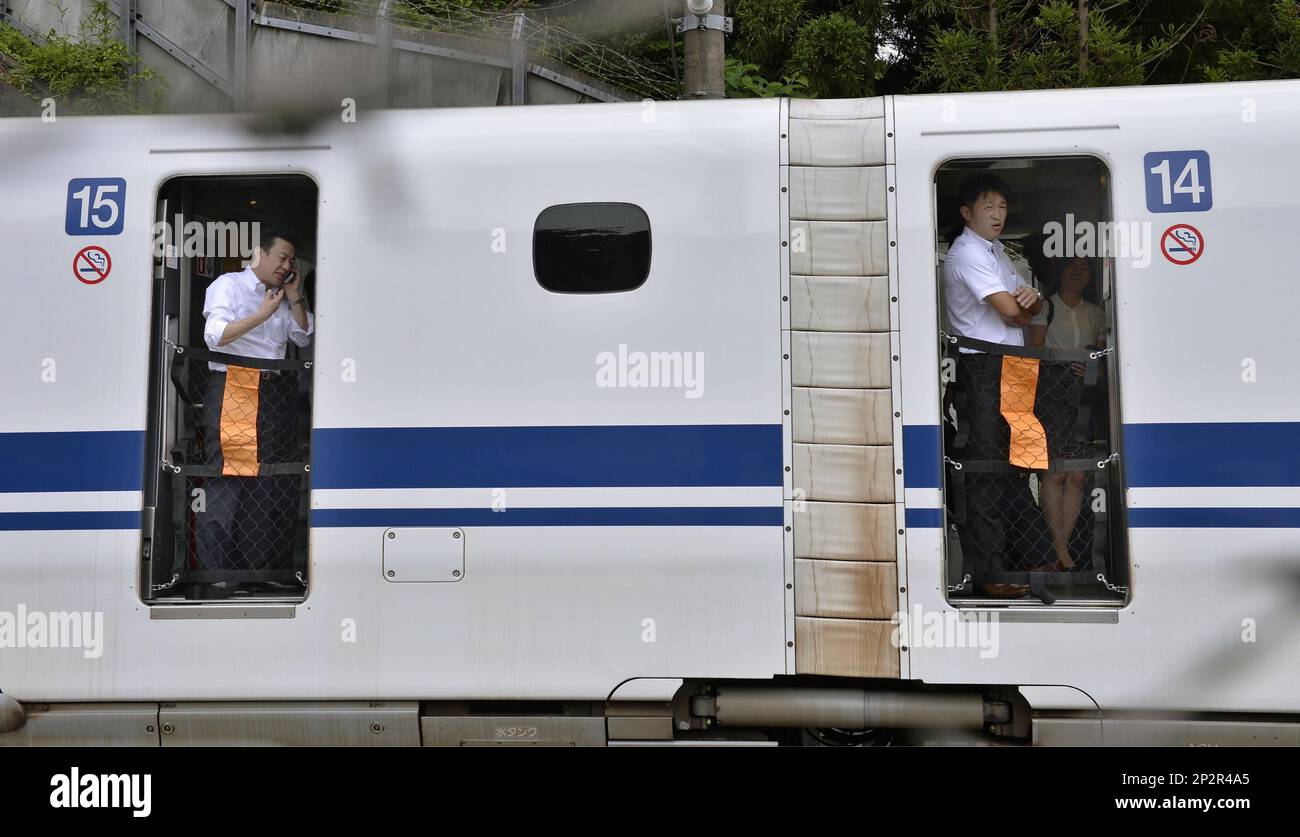 Passengers stand inside a Shinkansen bullet train which made an ...