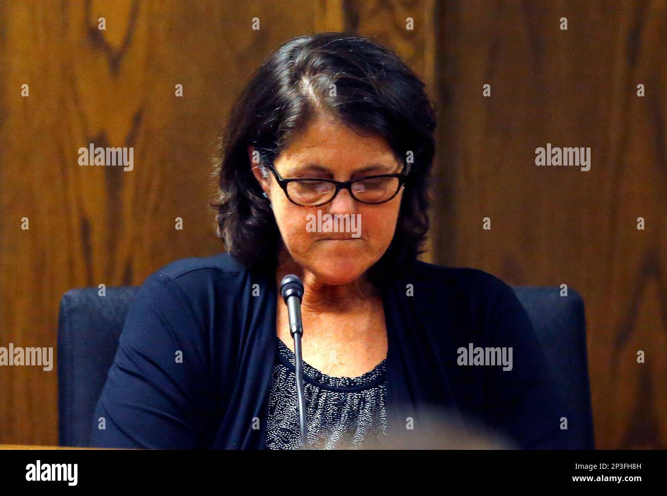 Jodi Routh, mother of Eddie Ray Routh, looks down after answering a ...