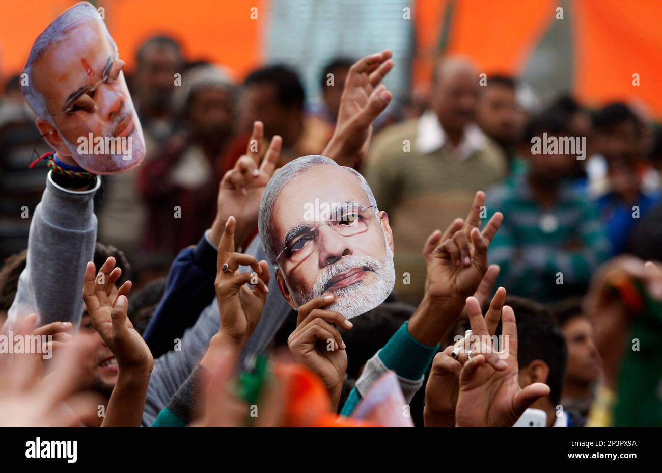 Supporter of India's ruling Bharatiya Janata Party (BJP) hold up masks ...