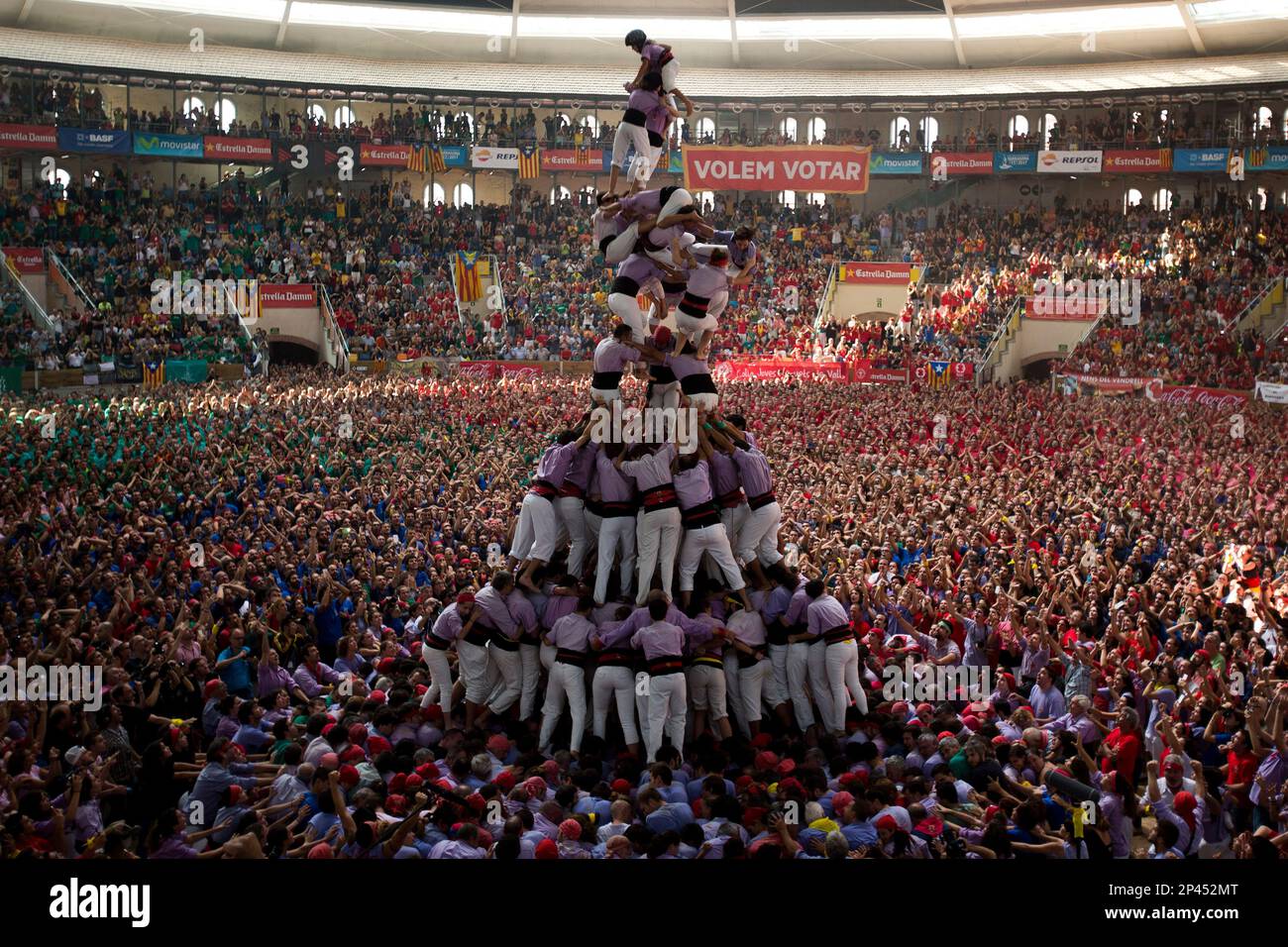 Members of the Castellers Collas Jove Xiquets de Tarragona fall as they ...