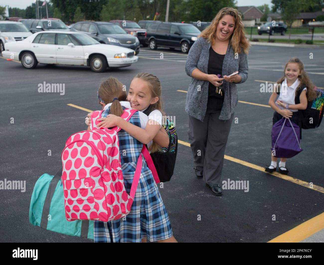Olivia Daenzer, right, hugs her friend Elliana Johnson at Nouvel ...