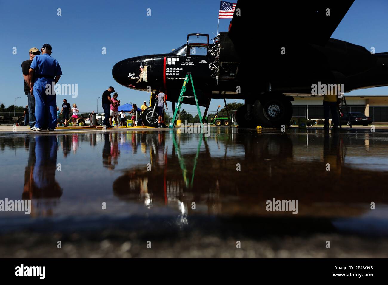 Water forms a puddle on the ground as the A-26 Lady Liberty is washed ...