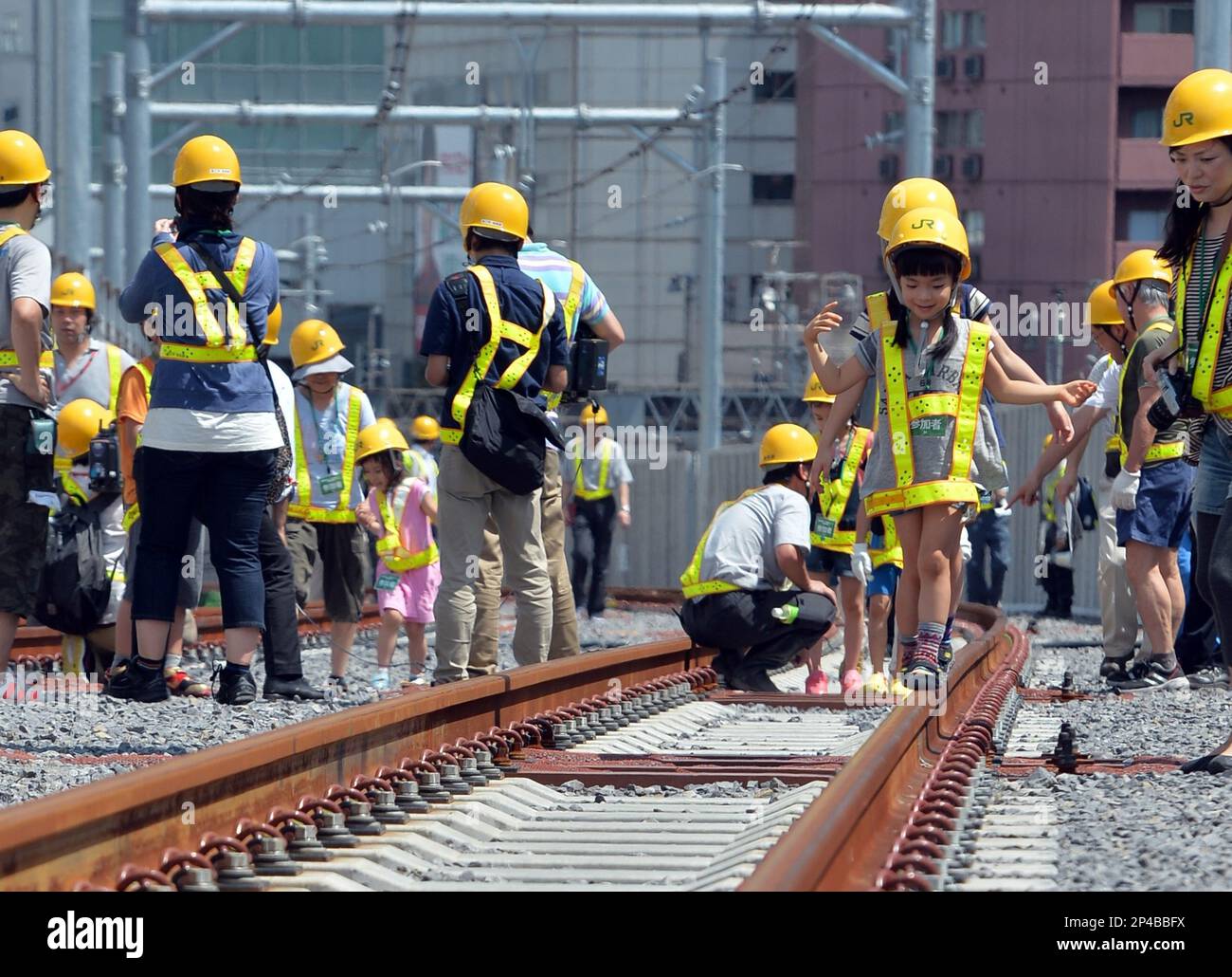 People in Tokyo walk on newly built tracks between Akihabara and Kanda ...