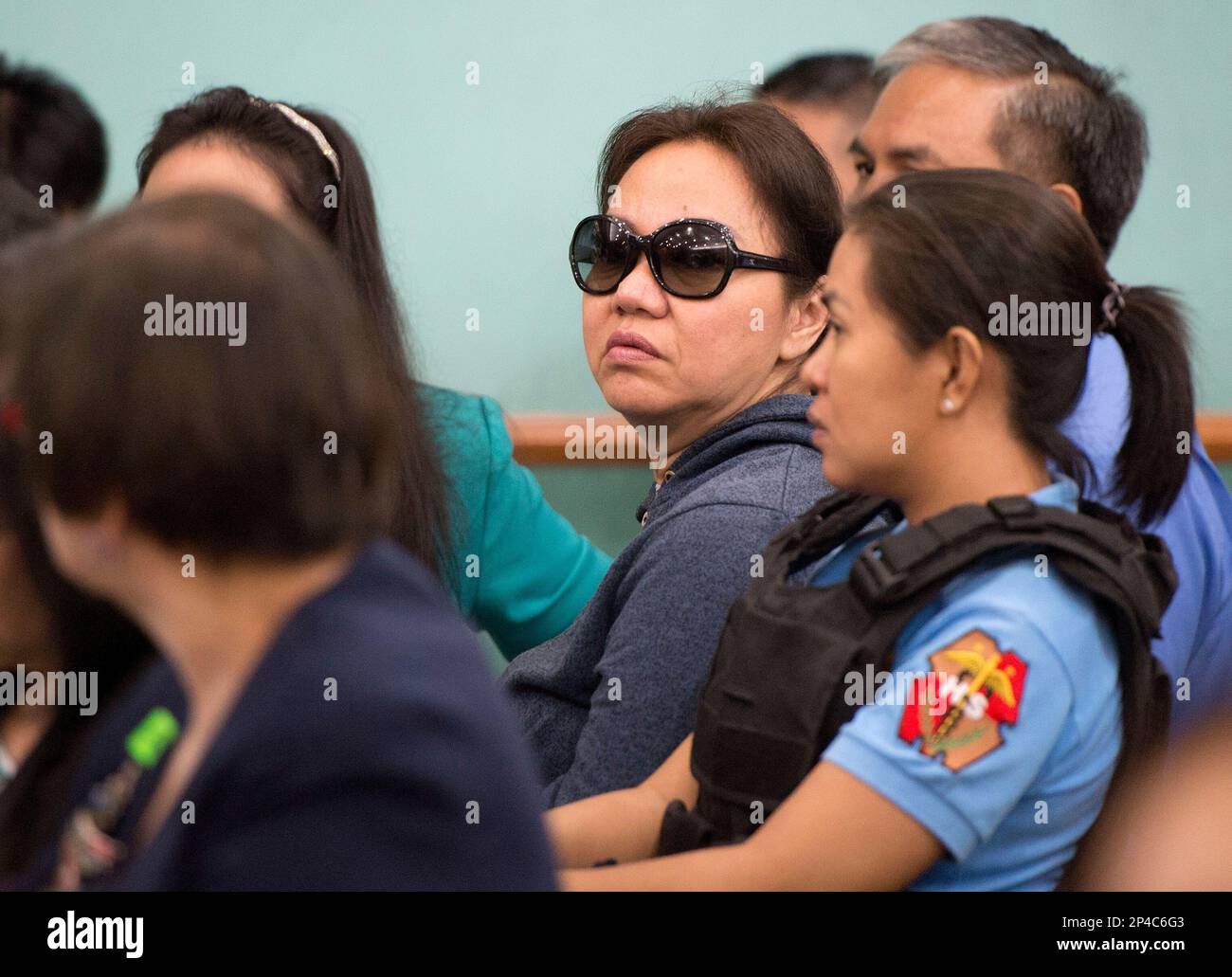 Janet Lim Napoles, center in sunglasses, a wealthy businesswoman at the ...