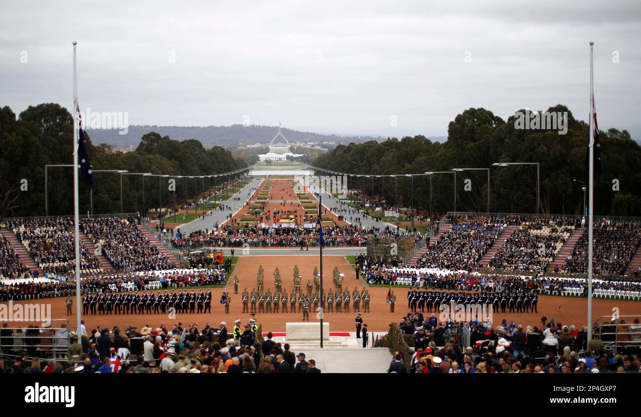 People line the avenue where Anzac Day ceremonies, attended by Britain ...