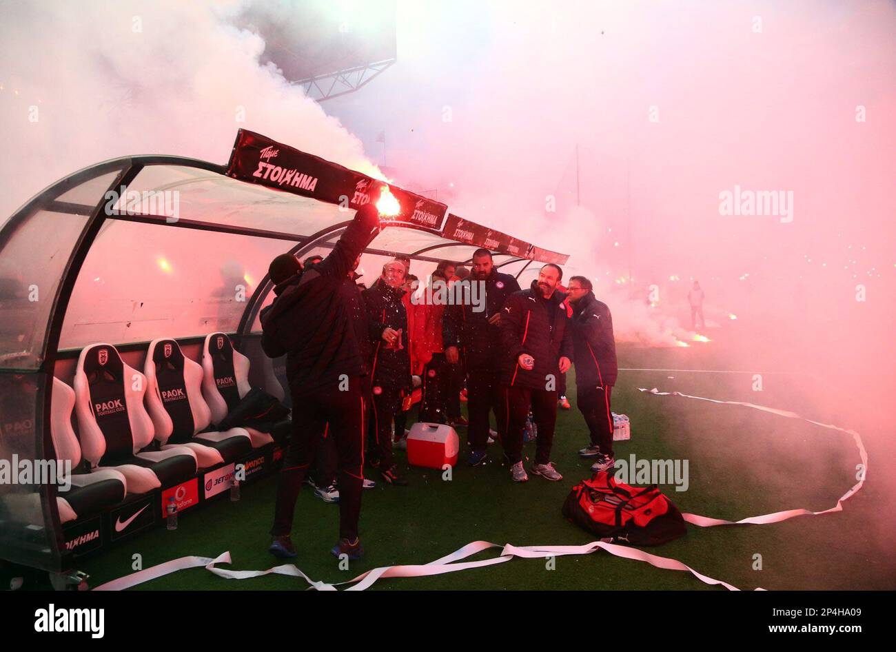 In this Wednesday, April 16, 2014 photo PAOK's fans throw flares, one ...