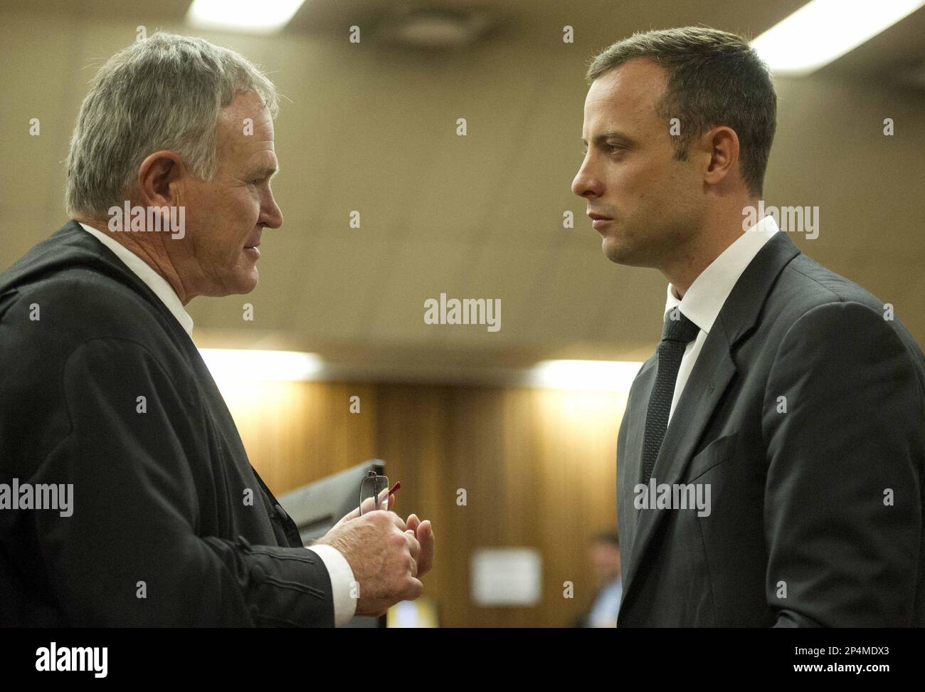 Oscar Pistorius, right, talks with his attorney, Barry Roux in court on ...