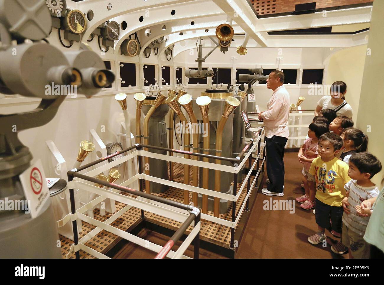 Visitors and children explore a re-created room of the Battleship ...