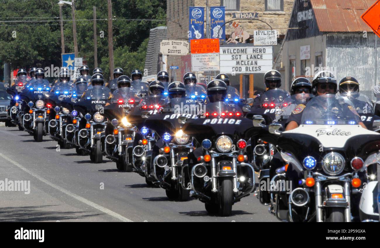 Motorcycle officers from several departments lead the casket in ...