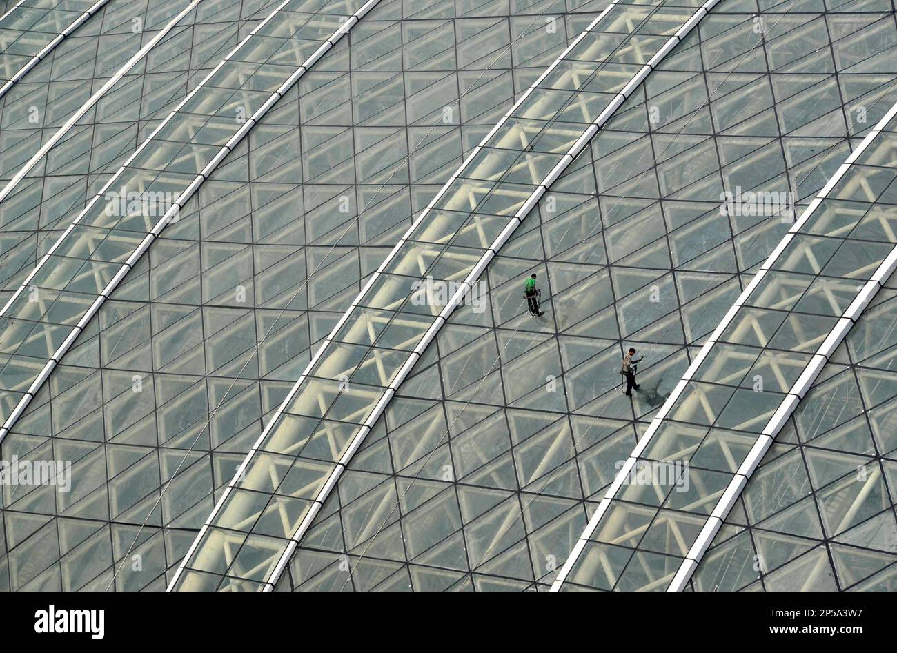Workers work on the roof of the newly-built New Century Global Center ...