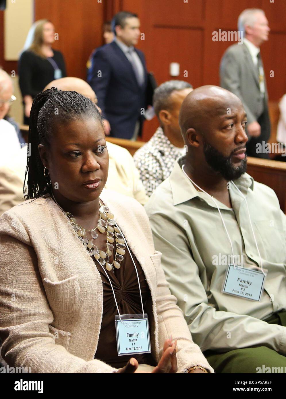 George Zimmerman arrives in court, background center, as Sybrina Fulton ...