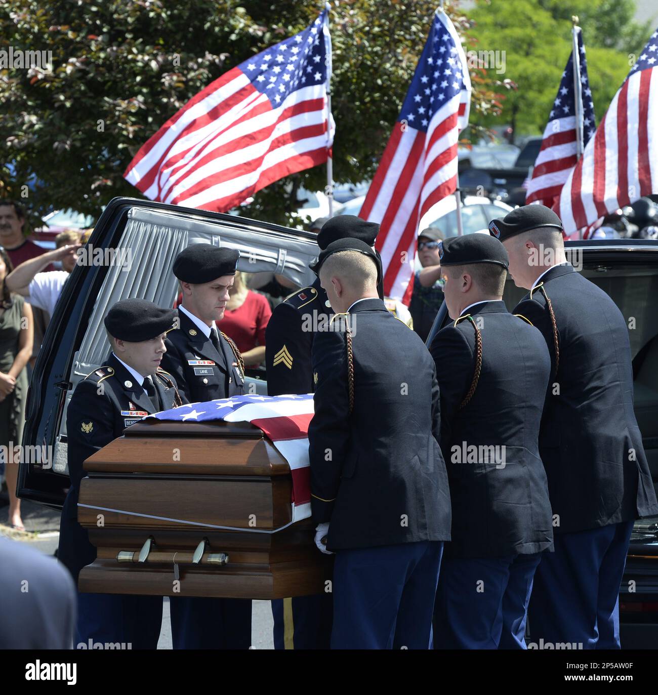 An Army honor guard removes the casket carrying the remains of Lt. Col ...