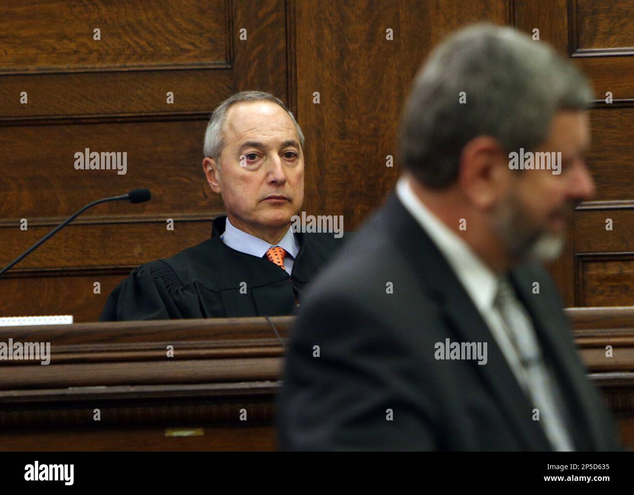 Chief Judge Larry T. Solomon listens as defense attorney Roger Falk ...