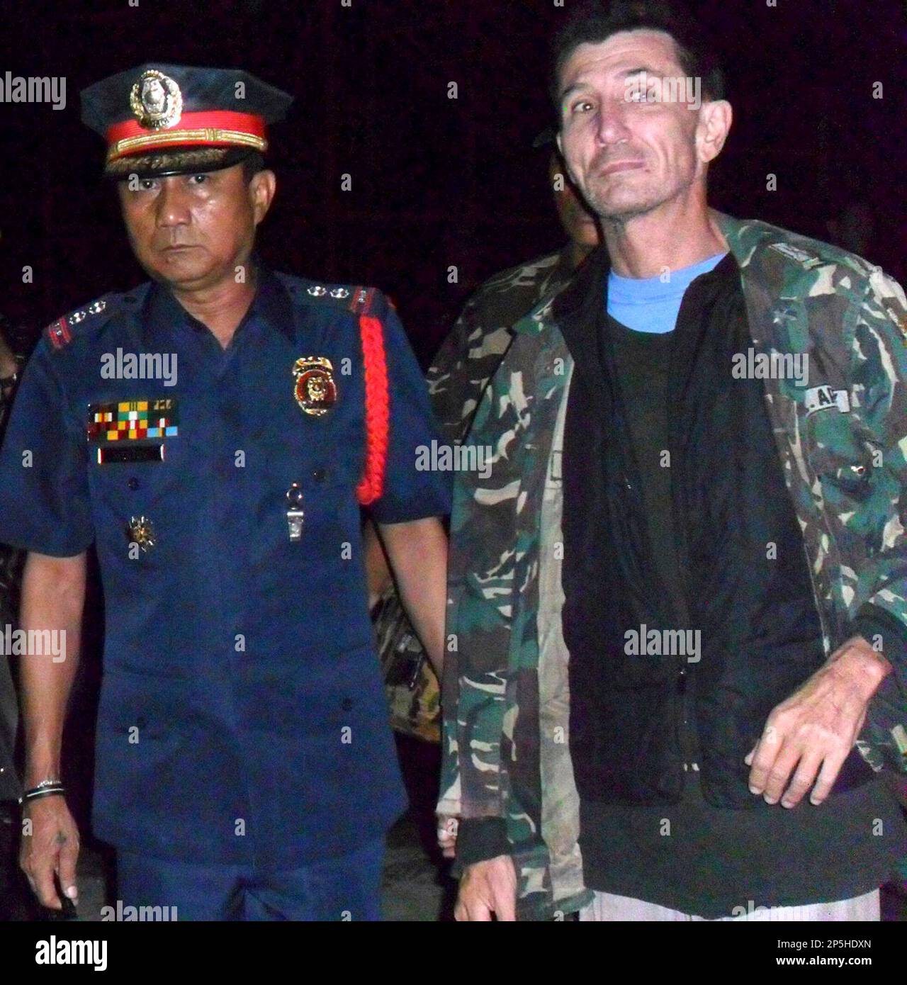 Australian hostage Warren Richard Rodwell, right, is escorted into the ...