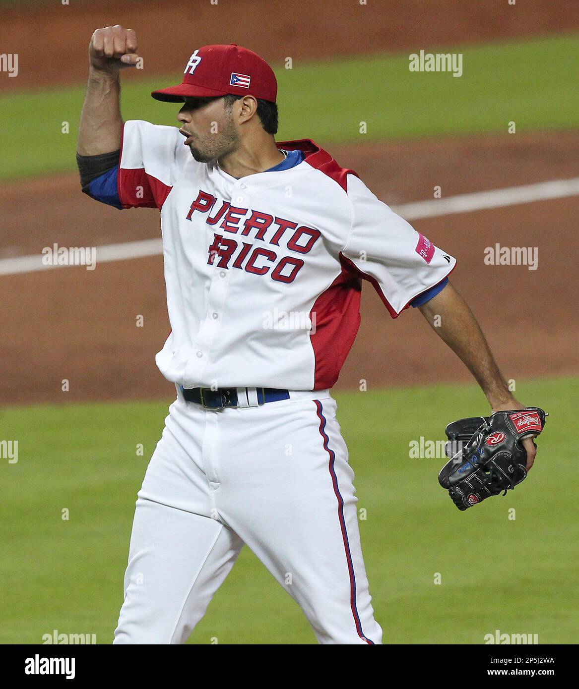 Puerto Rico pitcher Fernando Cabrera reacts after beating Italy 4-3 in ...