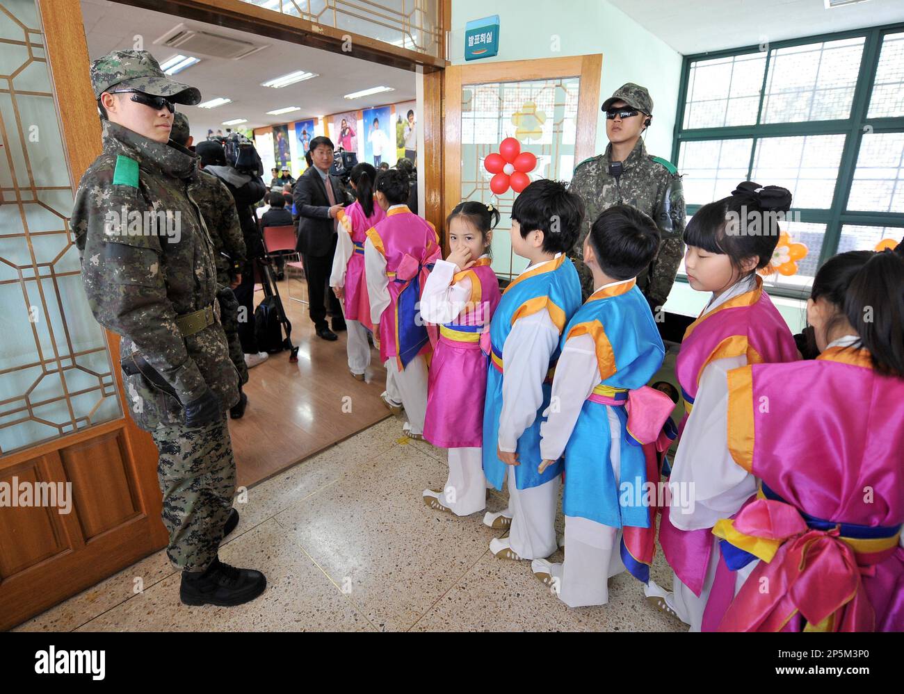 South Korean soldiers stand guard as students enter the hall during a ...