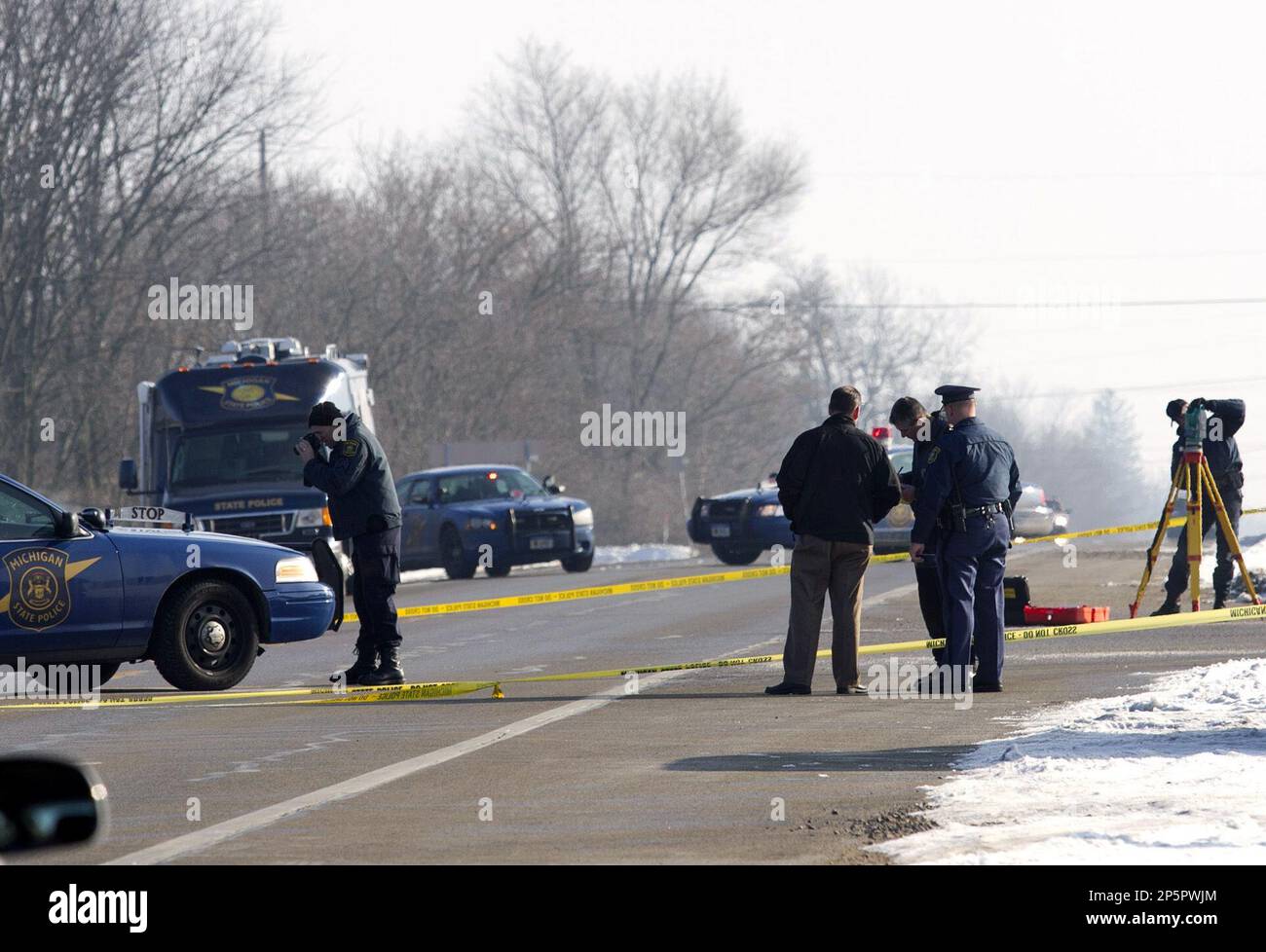 Police investigate the scene where a Belding police officer shot and ...