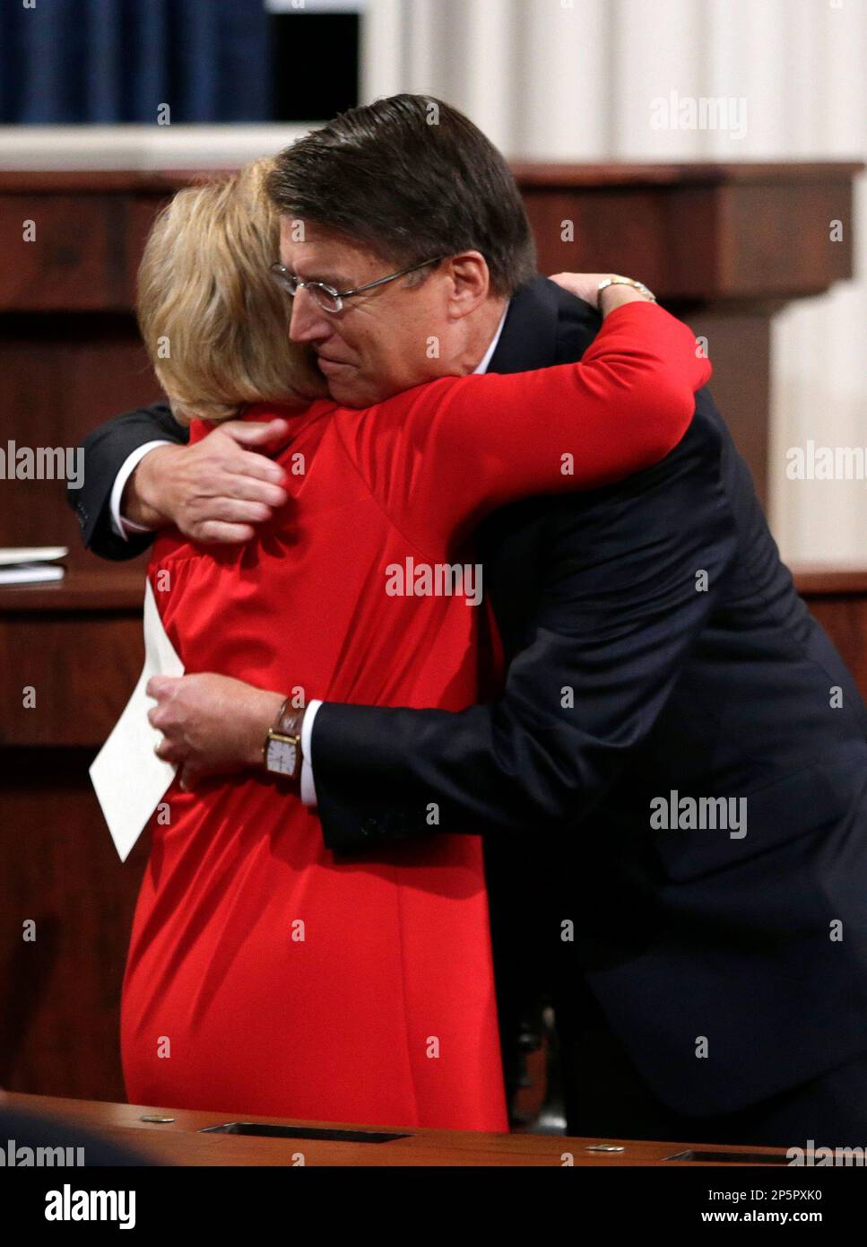 Gov.-elect Pat McCrory hugs outgoing Gov. Bev Perdue following the ...