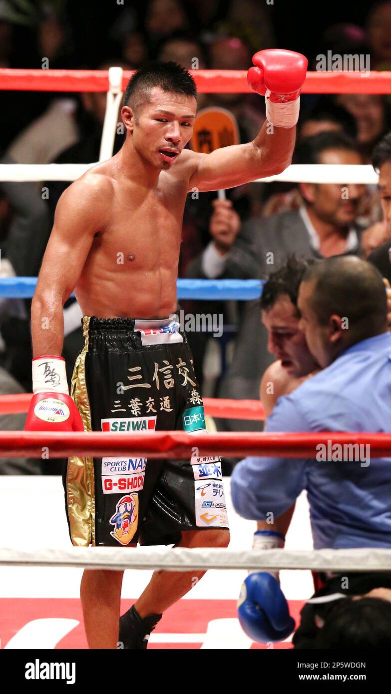 Japan's champion Takashi Uchiyama (L) reacts after a referee stopped ...